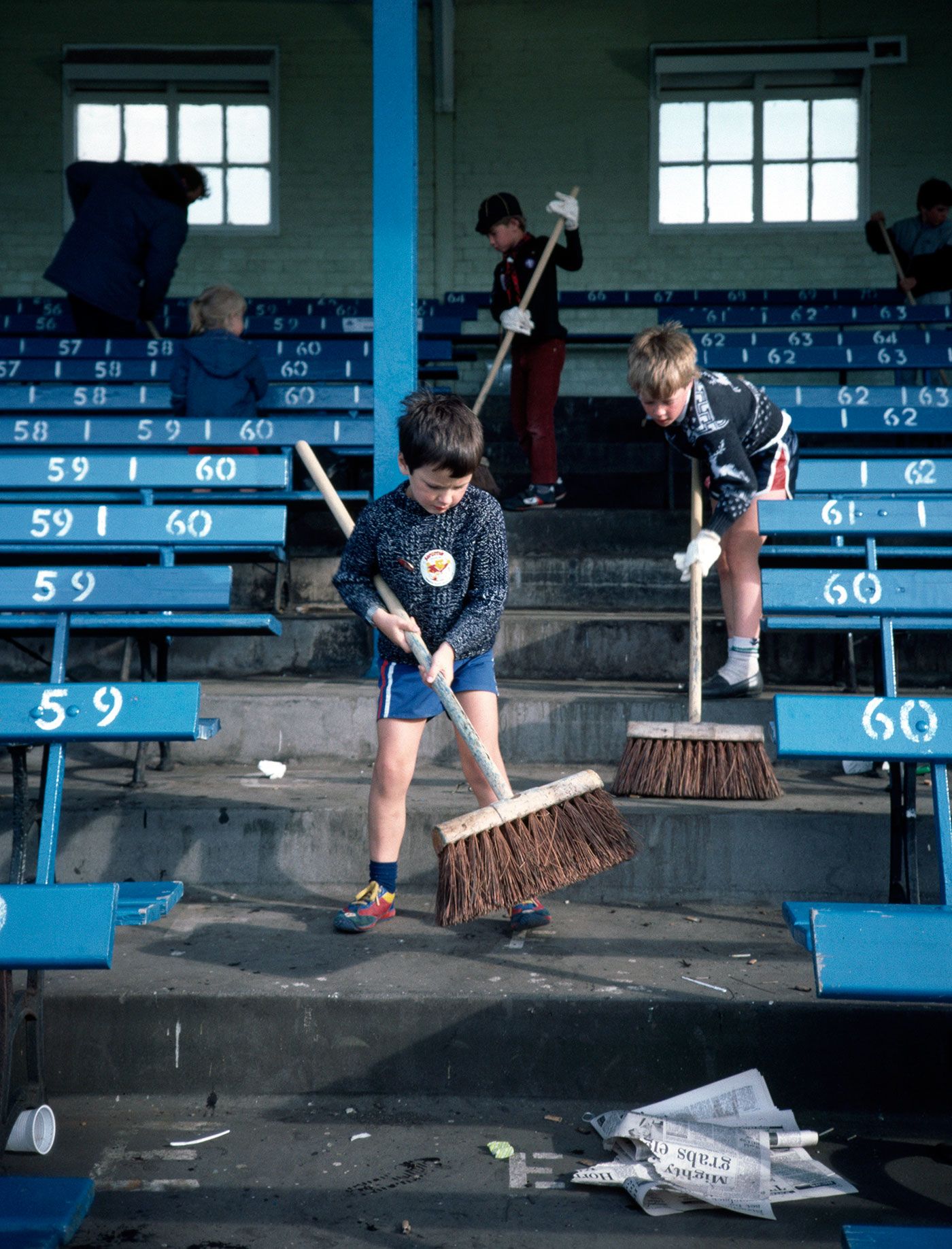 Young children sweep a stand at Old Trafford | ESPNcricinfo.com