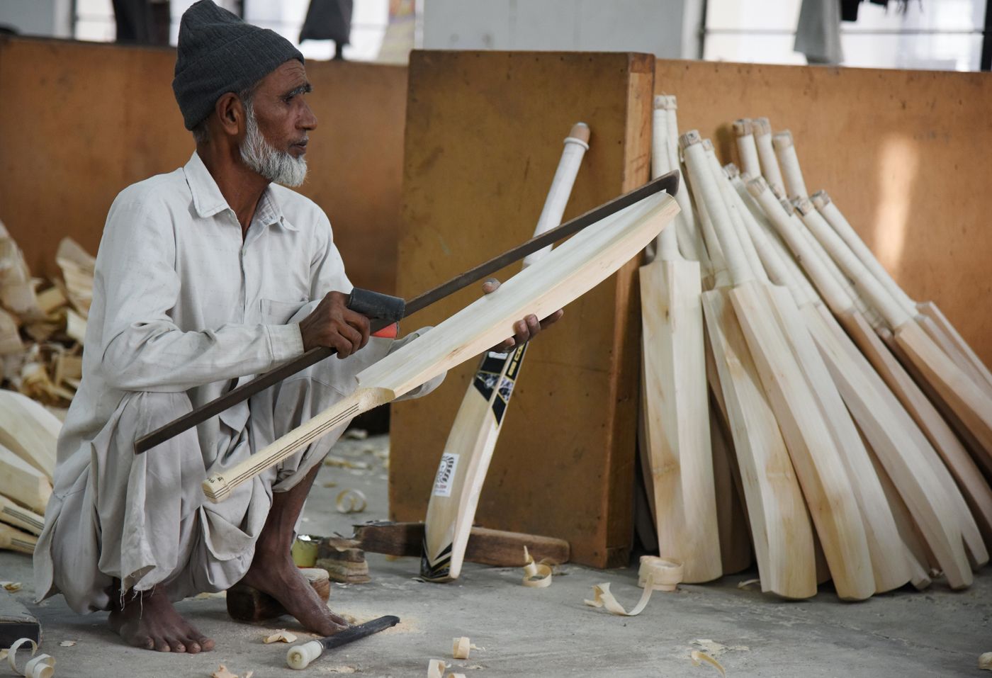 A craftsman works on a bat in a factory in Meerut | ESPNcricinfo.com