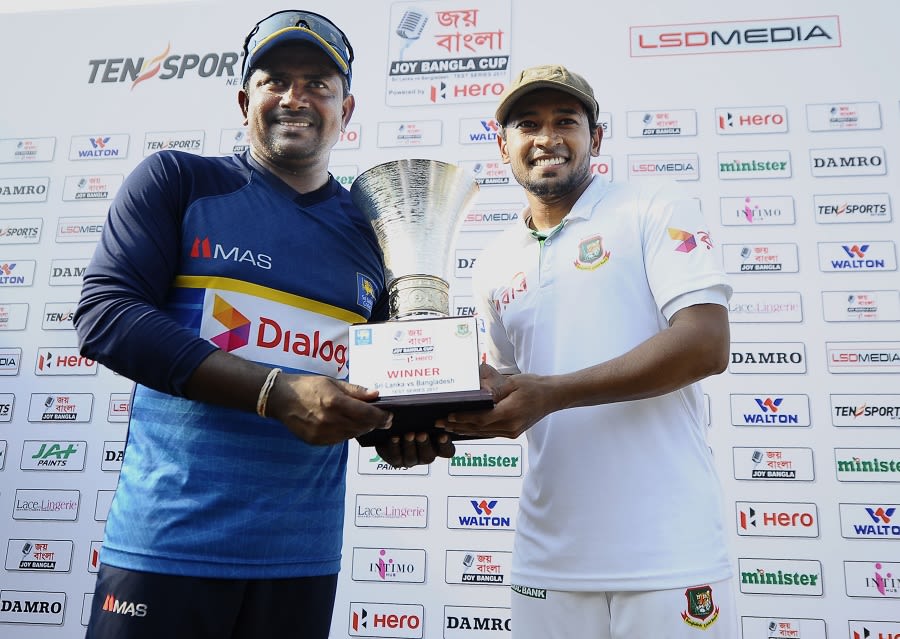 Rangana Herath and Mushfiqur Rahim pose with the trophy after the ...