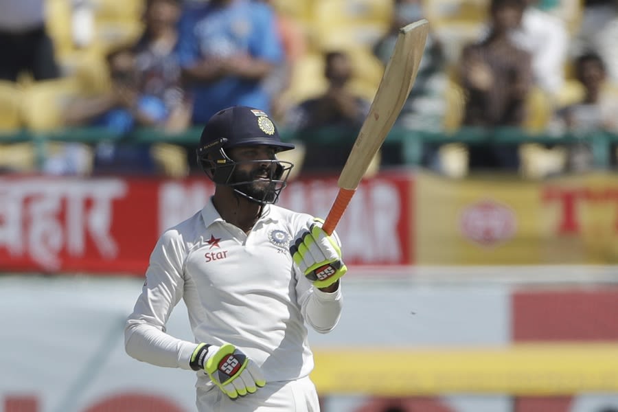 Ravindra Jadeja raises his bat after completing fifty runs ...
