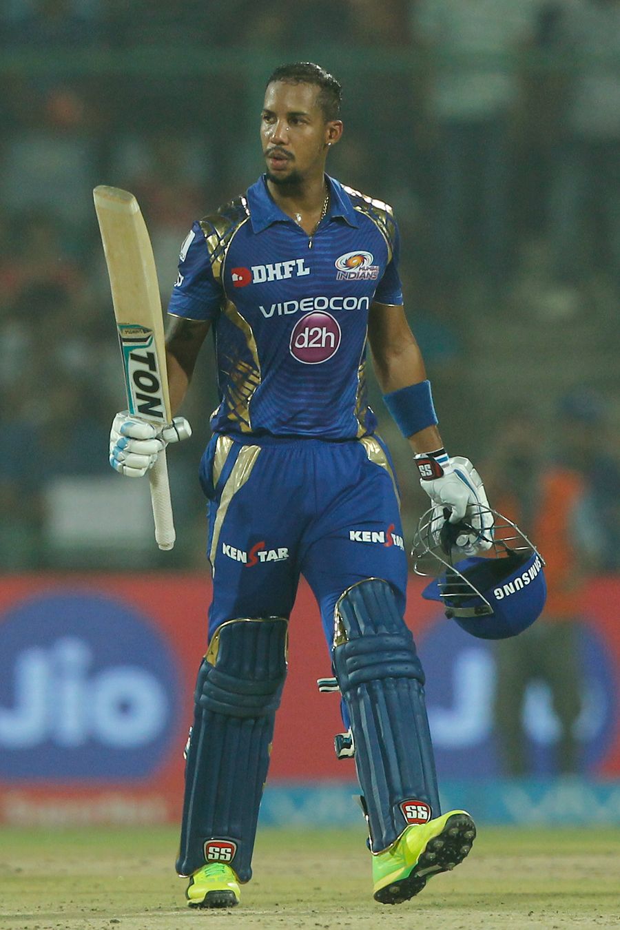 Lendl Simmons raises his bat after notching up his half-century ...