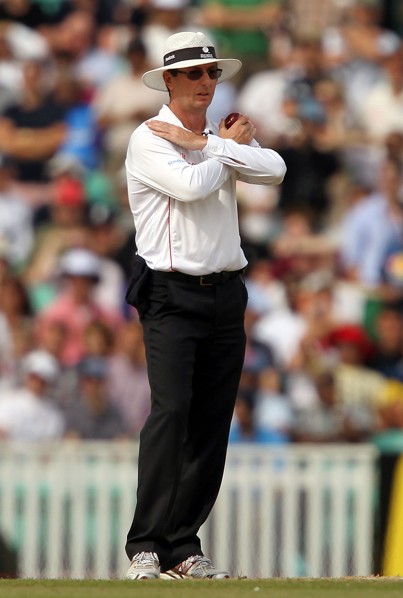 Umpire Rod Tucker signals a decision overturned on review ...