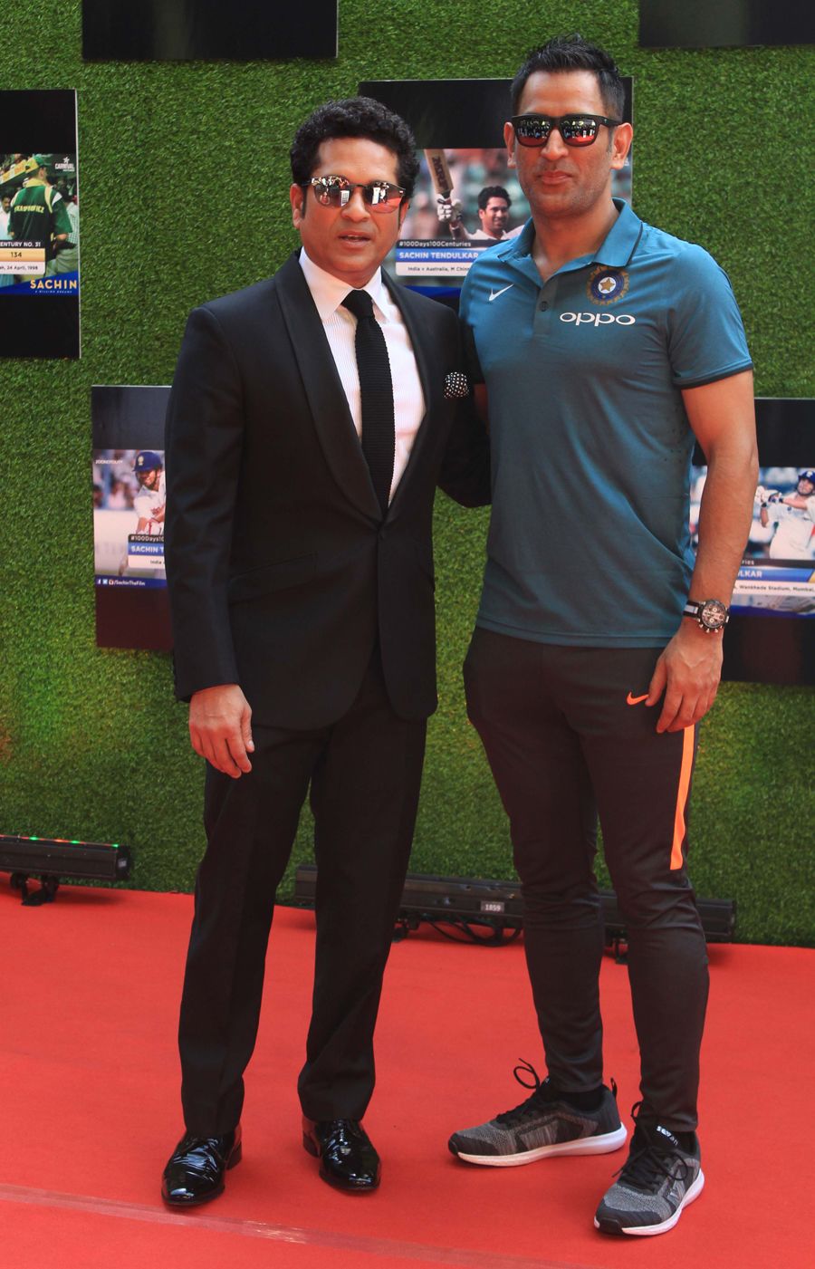 MS Dhoni poses with Sachin Tendulkar at the screening of the latter's ...