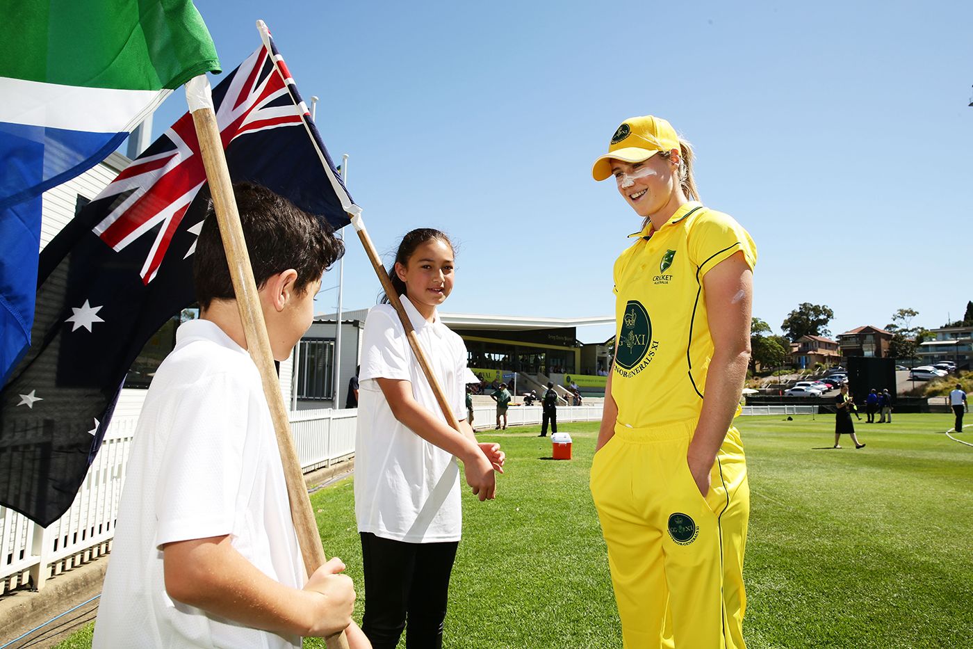 Ellyse Perry talks to two kids before the start of the match ...