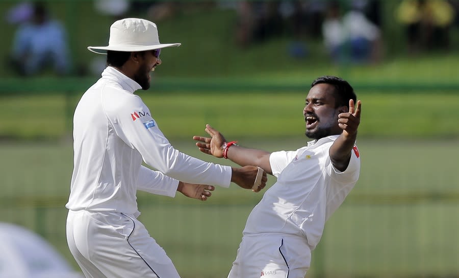 Dinesh Chandimal and Malinda Pushpakumara celebrate a wicket ...