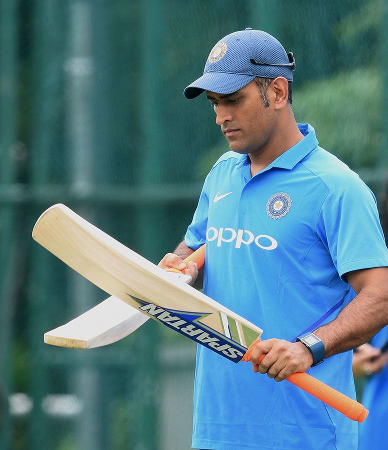 MS Dhoni inspects bats during training session | ESPNcricinfo.com