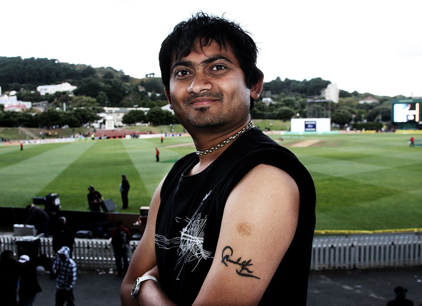 A fan shows off his tattoo of Sachin Tendulkar's autograph on his arm ...