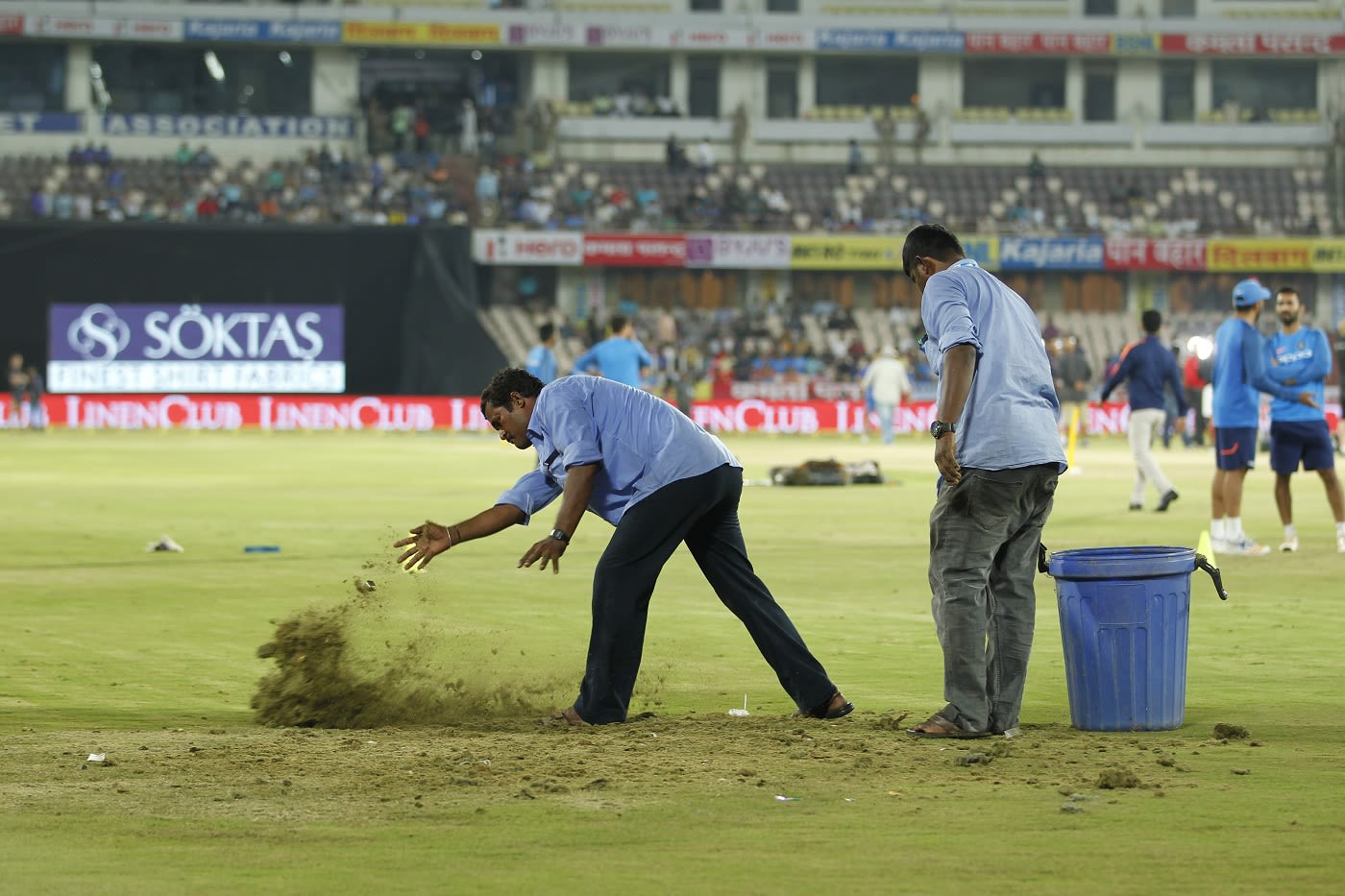 The Hyderabad groundstaff sprinkle sawdust on wet patches ...