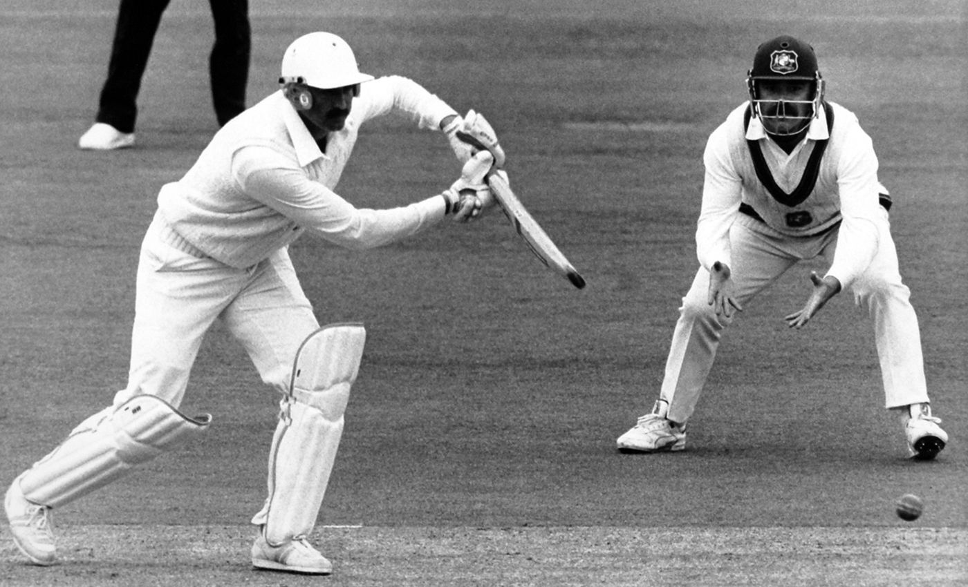 Graham Gooch plays a shot watched by David Boon at short leg ...