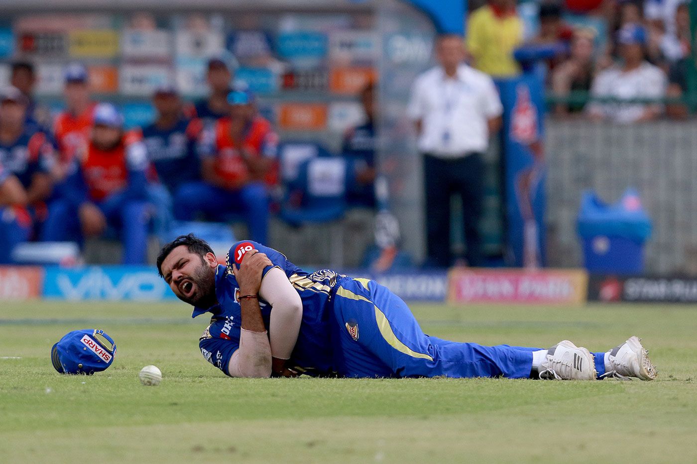 Rohit Sharma clutches his shoulder after a fielding effort ...