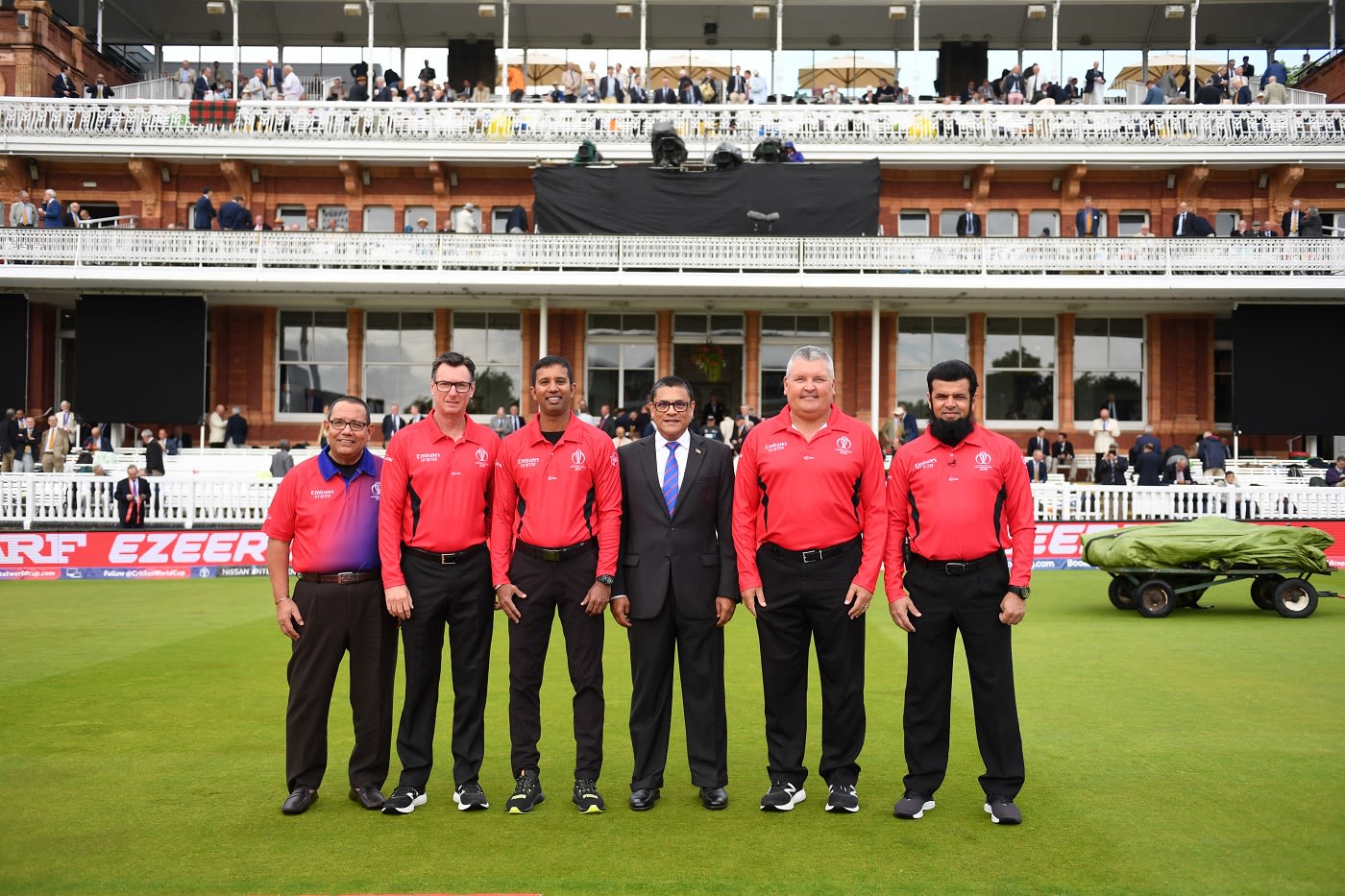 The match officials and referee pose for a picture before the match ...