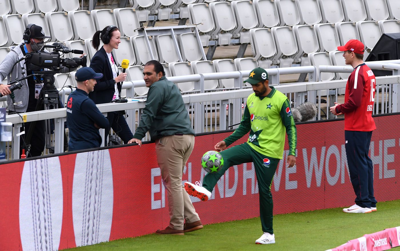 Babar Azam kicks a football around while waiting to be interviewed ...