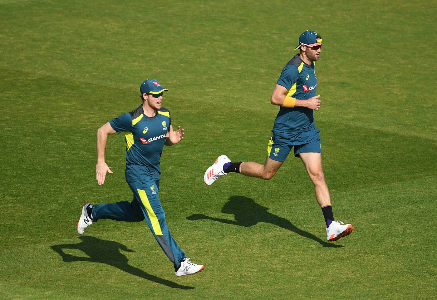 Steven Smith (left) runs alongside AJ Tye during training ...