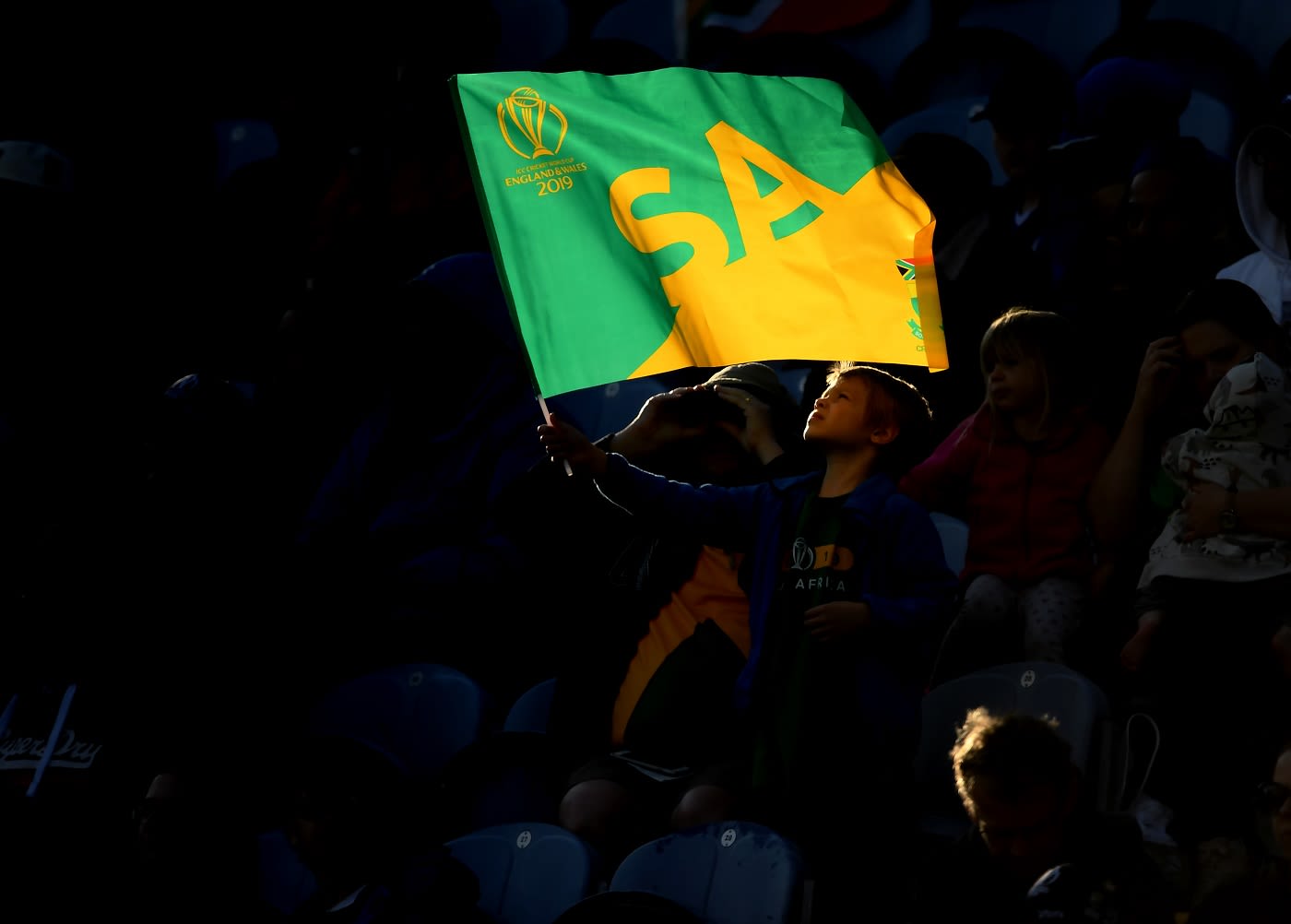 A young South Africa fan waves a flag in support of his country ...