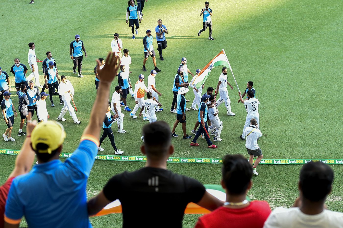 Fans greet the Indian players on their victory lap around the Gabba ...