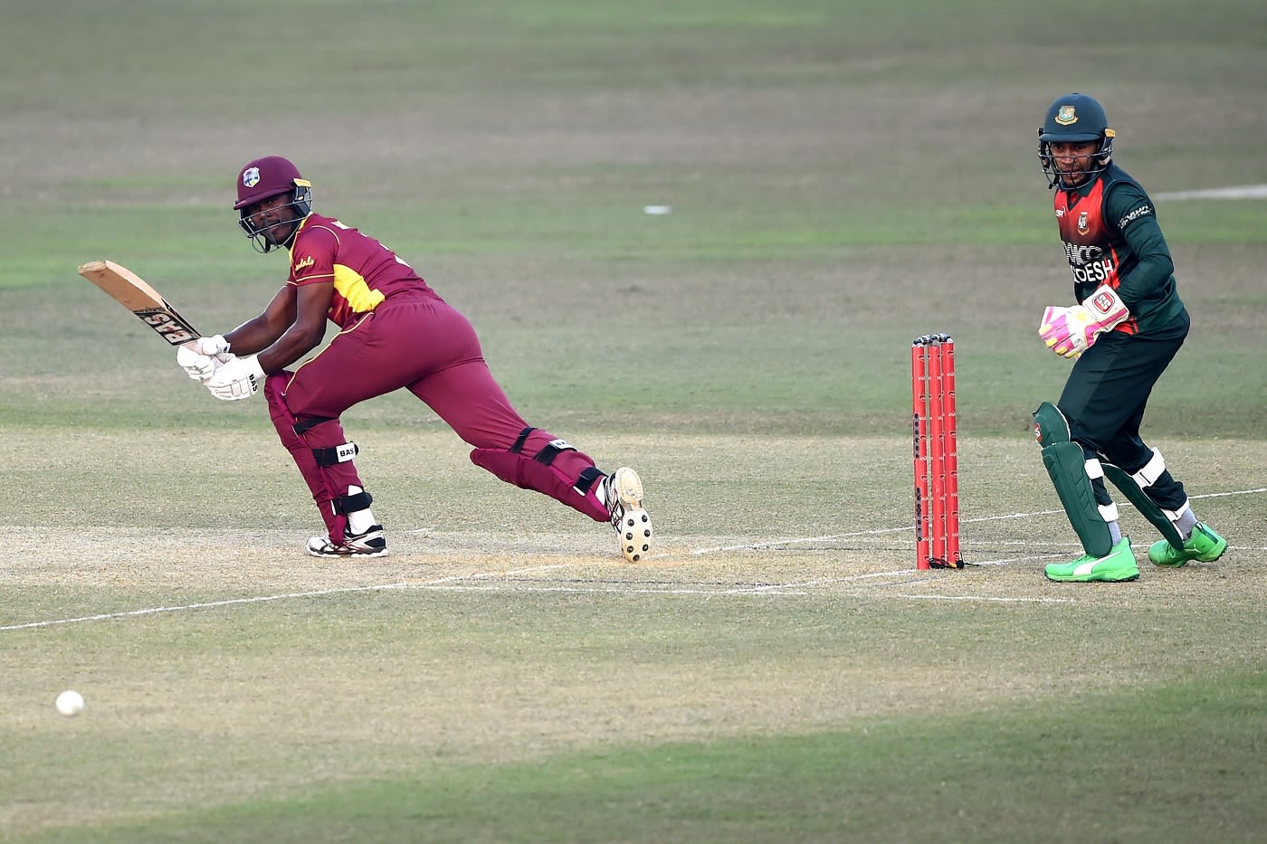 West Indies captain Jason Mohammed lunges forward to play a shot ...