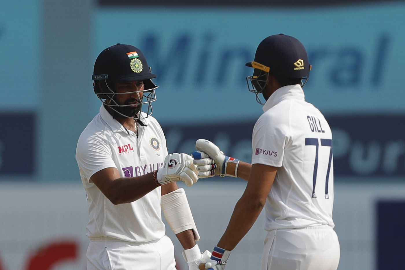 Cheteshwar Pujara and Shubman Gill punch gloves during their ...