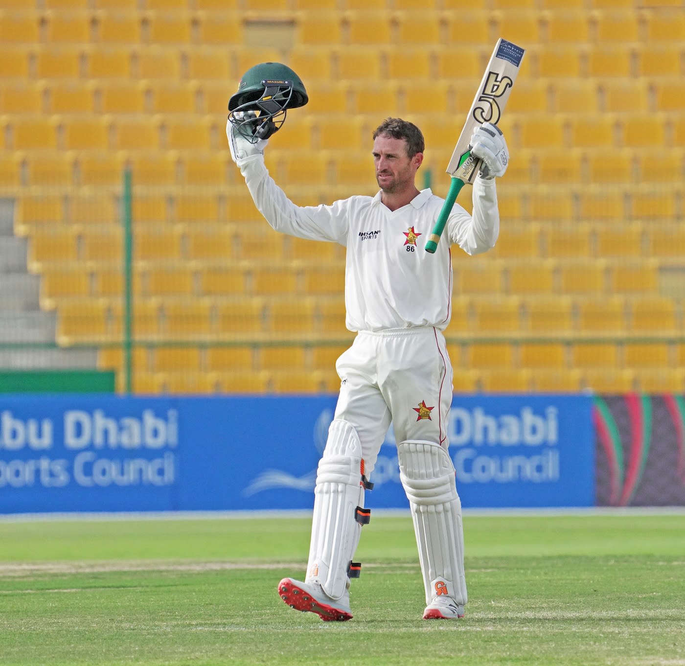 Sean Williams raises his bat after reaching his century | ESPNcricinfo.com