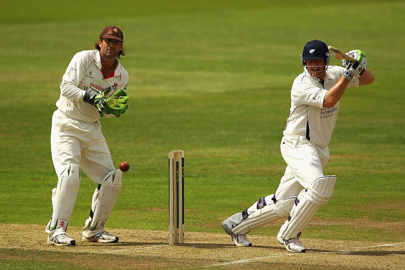 Luke Sutton looks on as Anthony McGrath plays into the off side ...