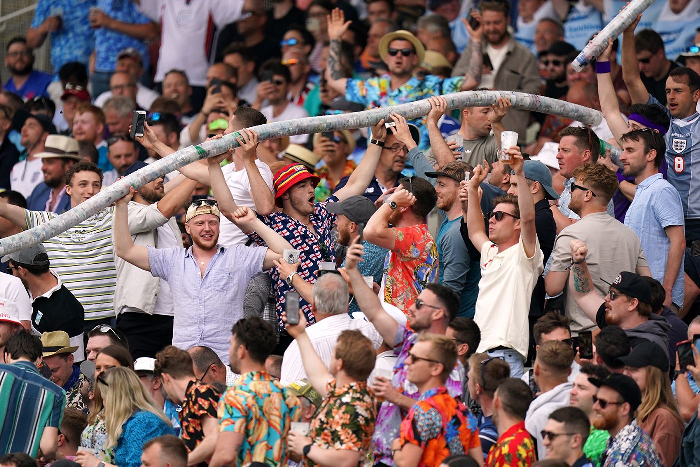 Fans in the stands make a beer snake out of empty plastic pint cups ...