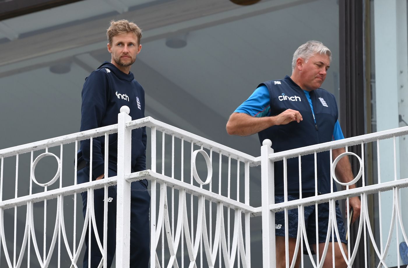 Joe Root and Chris Silverwood look on as the rain comes down ...