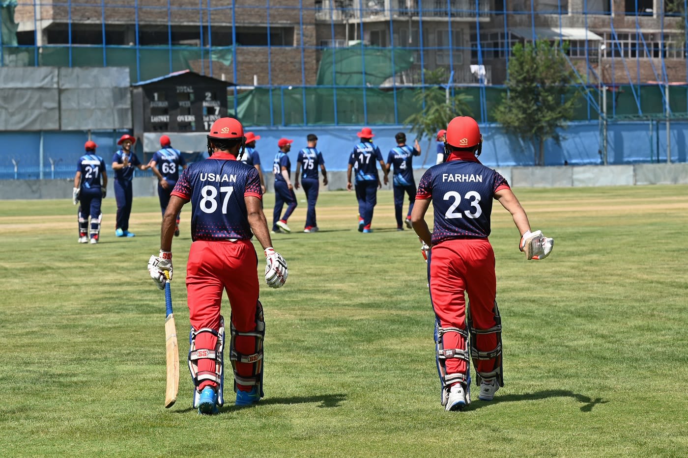Peace Heroes team players Usman and Farhan walk into the field during ...