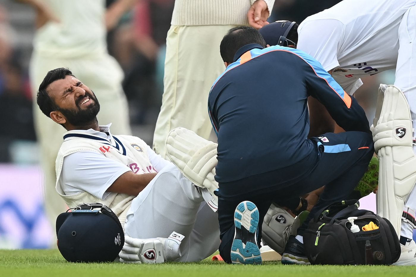 Cheteshwar Pujara winces in pain as he gets attention for a sprained ...