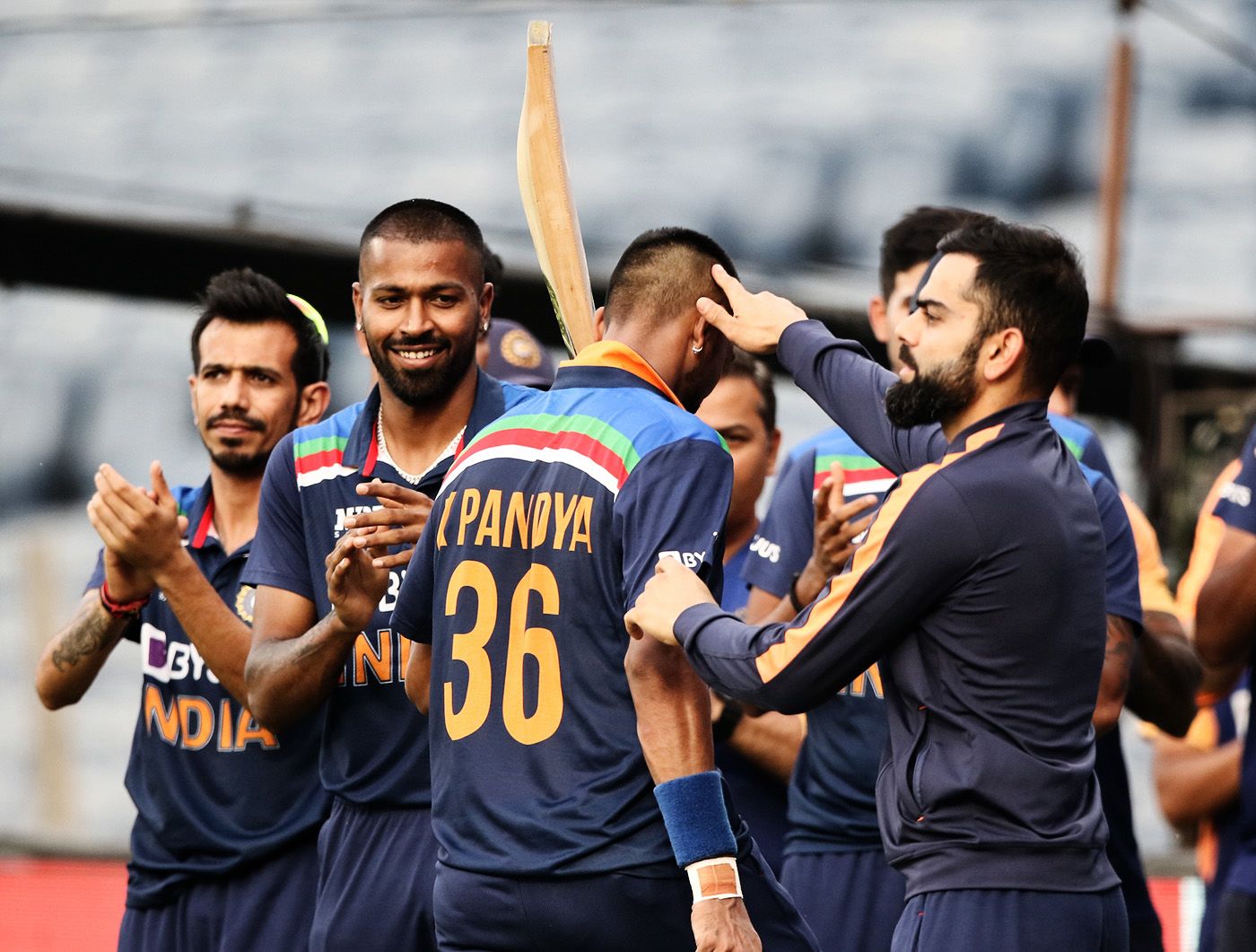 Virat Kohli, Hardik Pandya and Yuzvendra Chahal applaud Krunal Pandya as he makes his way back ...