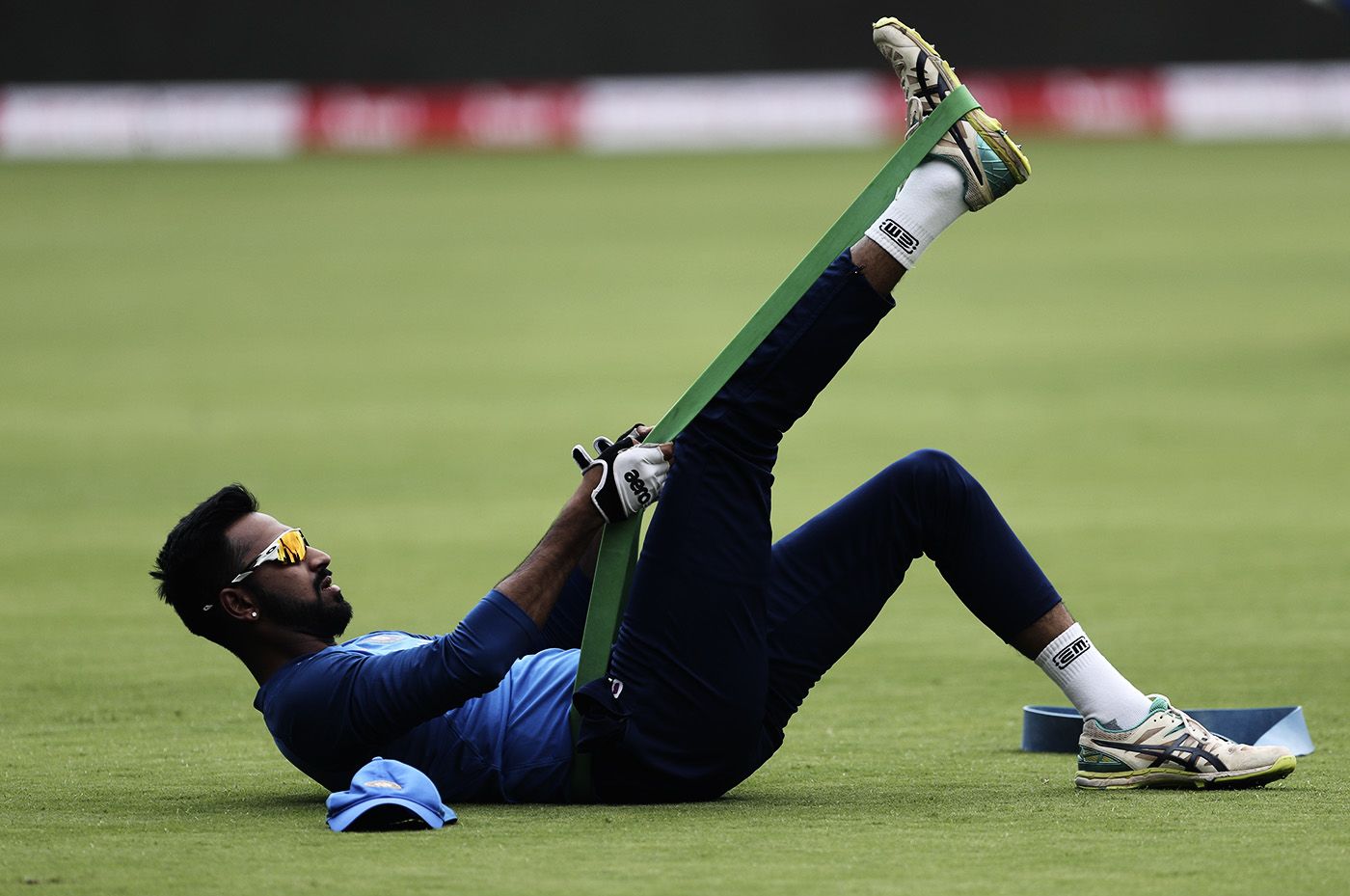Krunal Pandya uses a resistance band to stretch his leg | ESPNcricinfo.com