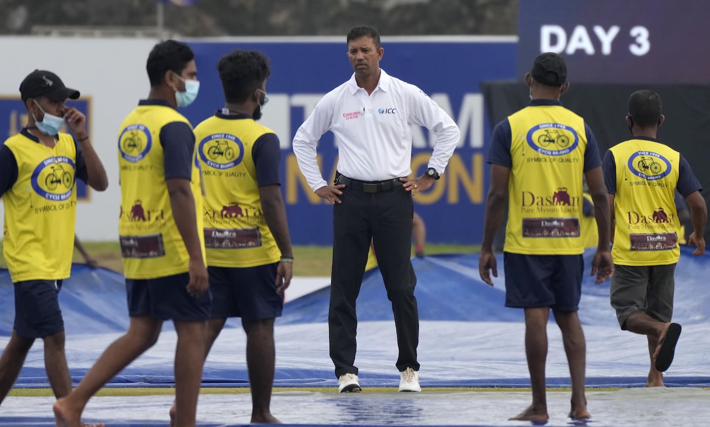Umpire Kumar Dharmasena inspects the ground after some rain ...