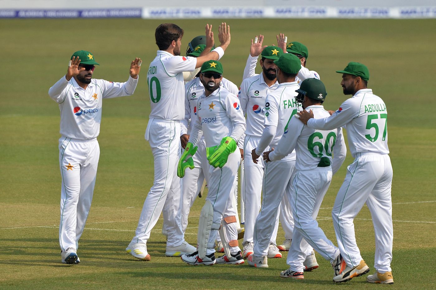 Shaheen Afridi celebrates the wicket of Saif Hassan with his team-mates ...