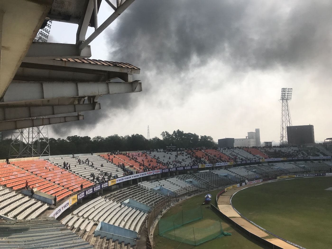 A thick cloud of smoke over the stadium after a fire nearby ...