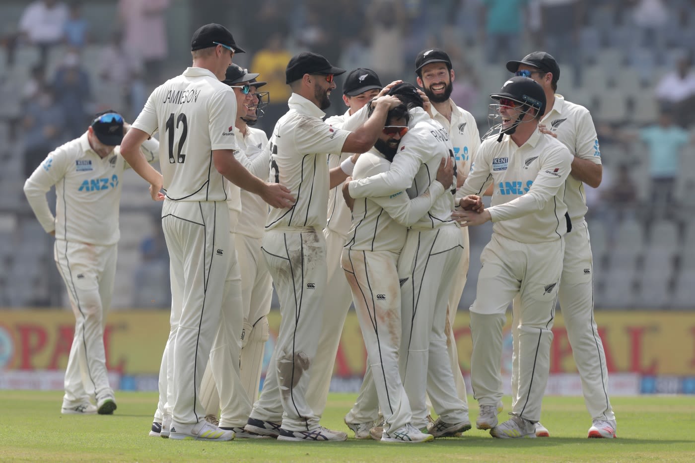 The New Zealand players congratulate Ajaz Patel after he picked up his ...