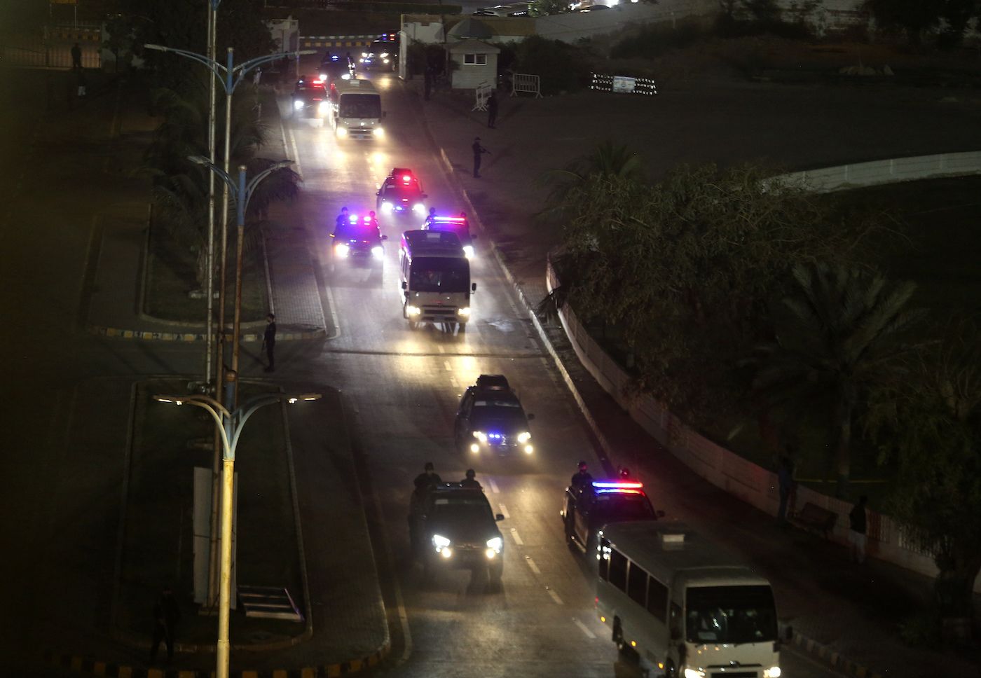 A police convoy escorts mini buses carrying West Indies and Pakistan ...