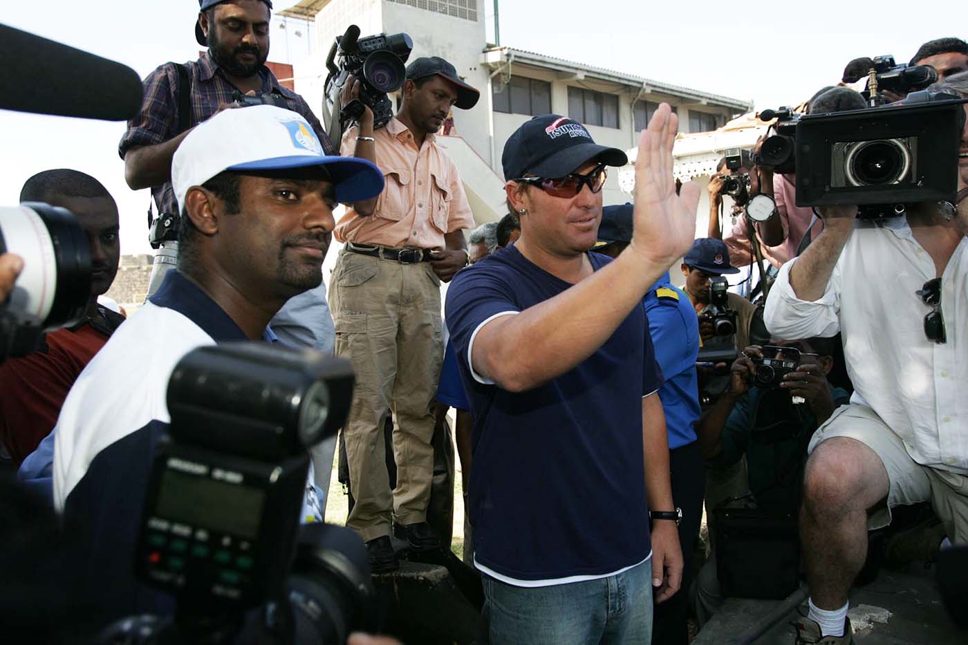 Muthiah Muralidaran and Shane Warne visit a tsunami refugee camp in ...