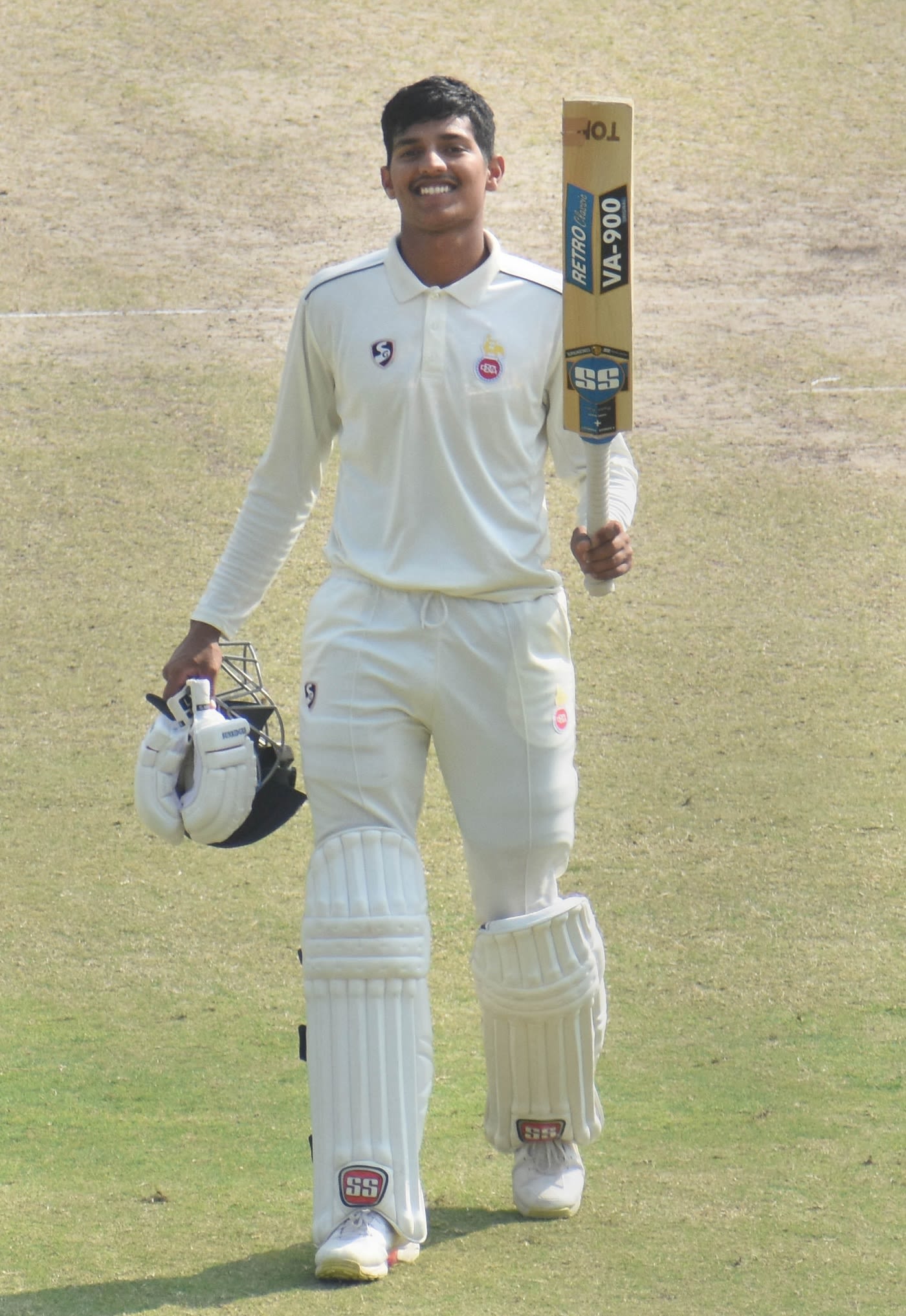 Yash Dhull raises his bat after reaching a double-century ...