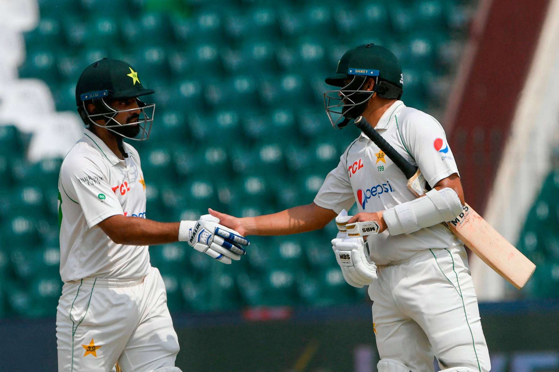 Azhar Ali shakes hands with Abdullah Shafique after his knock ...