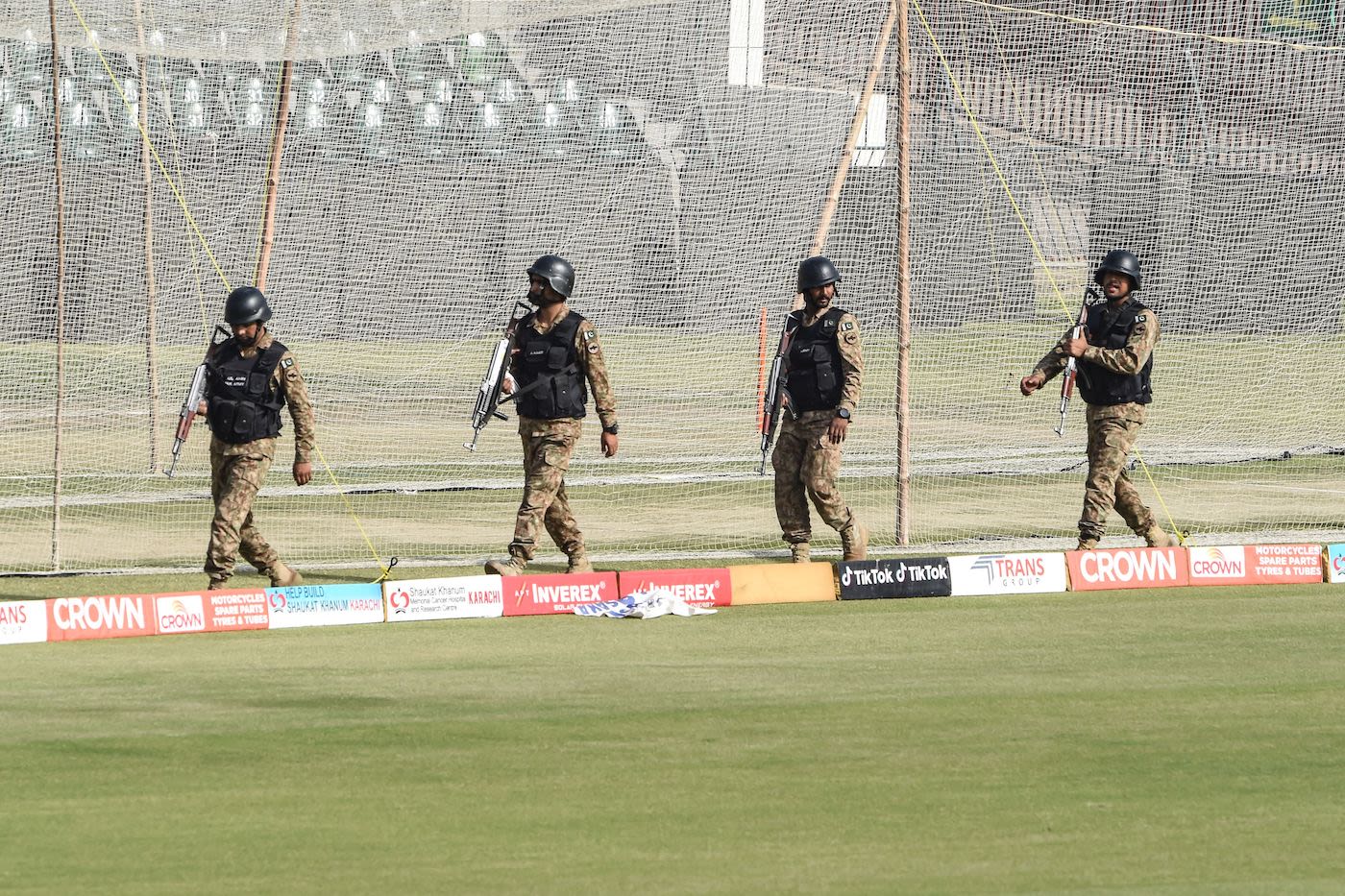 Pakistani army soldiers walk on the sidelines of the training sessions ...
