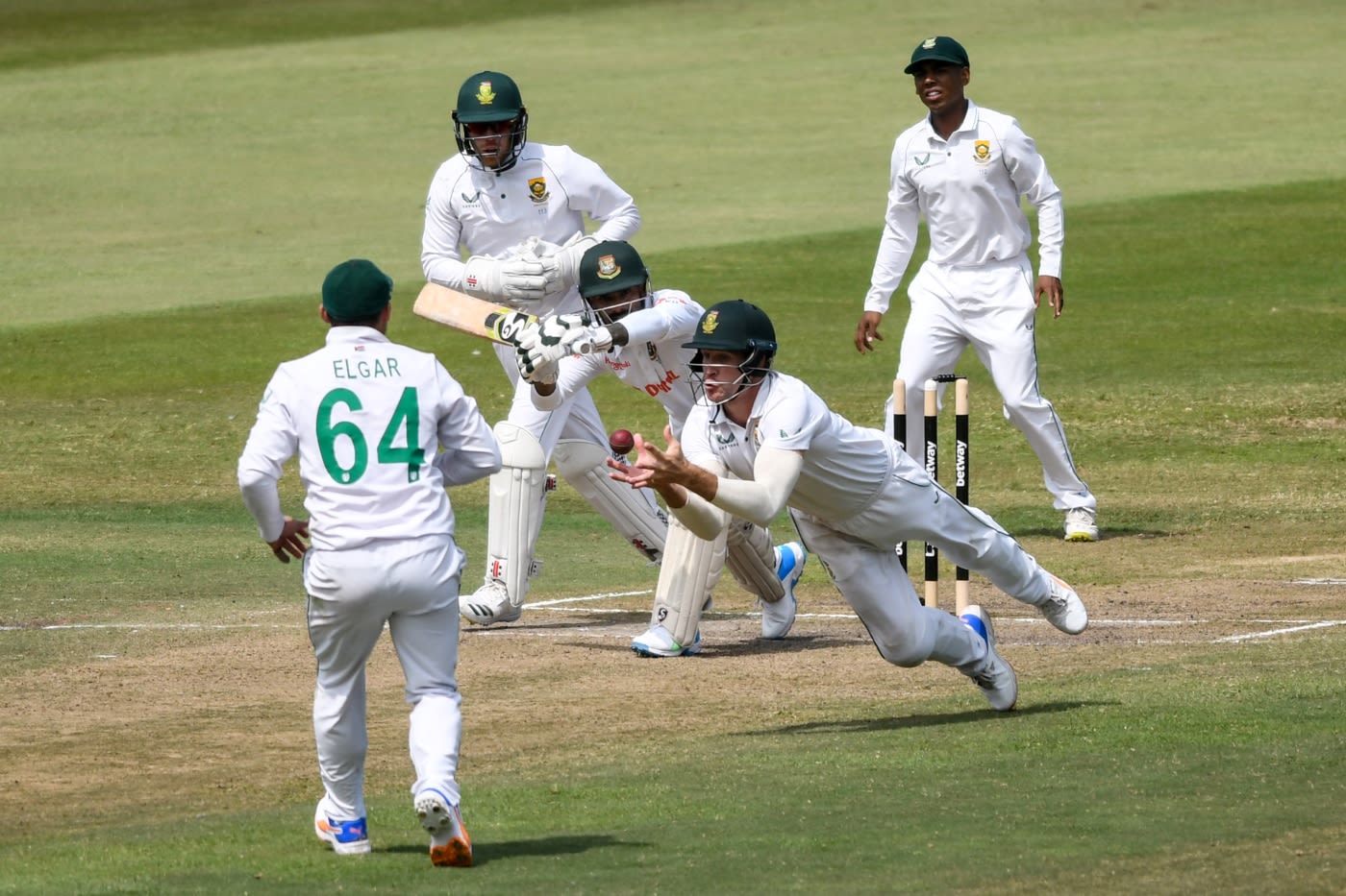 Sarel Erwee dives at short leg to catch a ball off Litton Das' pad ...