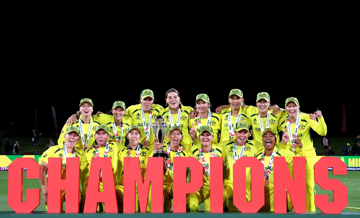 The Australian team poses with the World Cup trophy | ESPNcricinfo.com