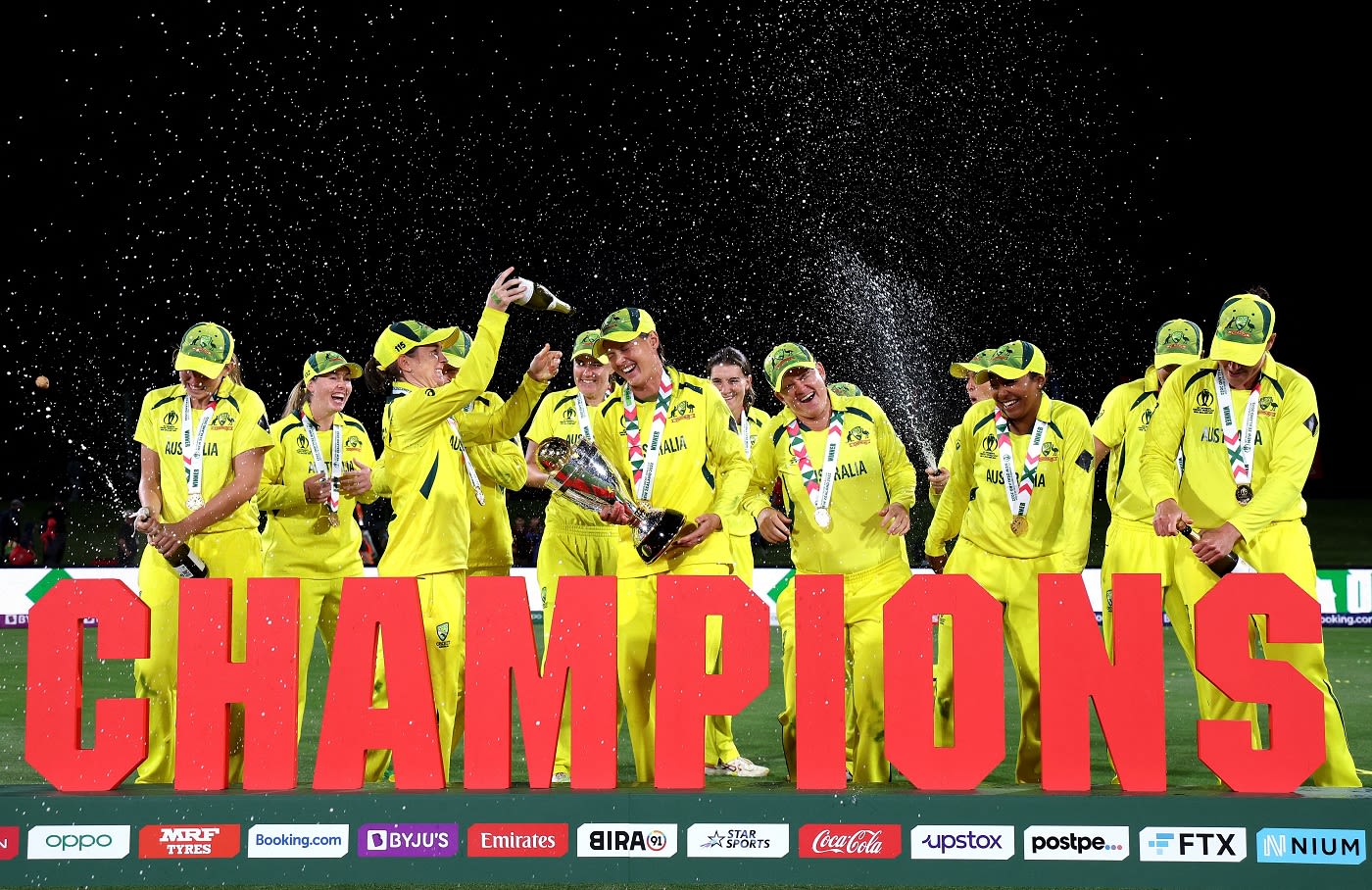 The Australian players celebrate with the trophy | ESPNcricinfo.com