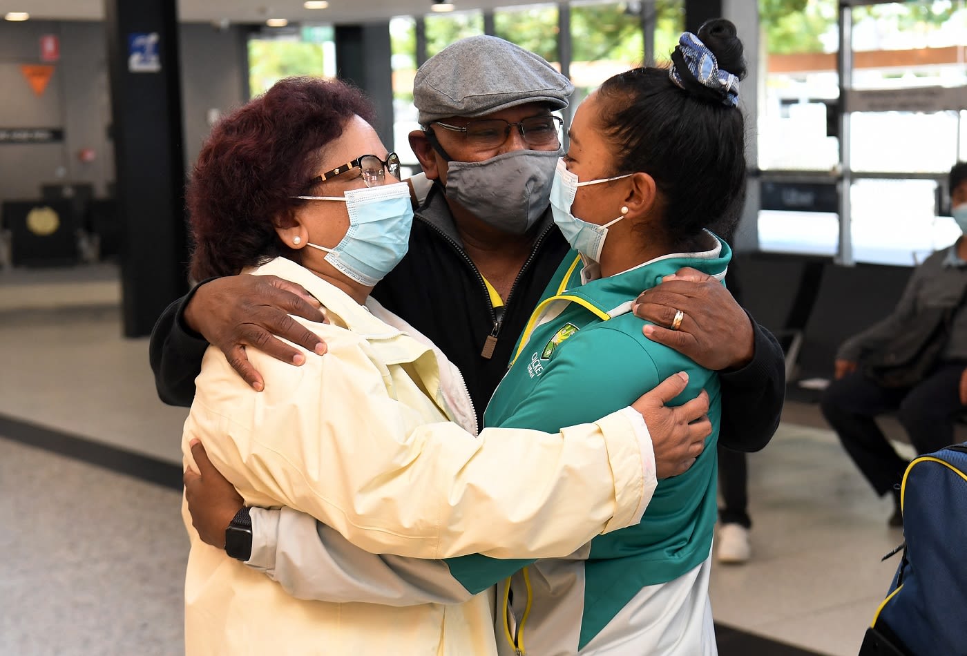 Alana King is greeted by her parents after arriving in Melbourne ...
