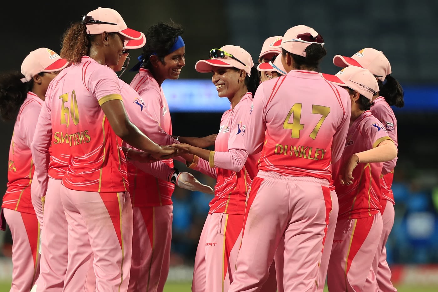 Salma Khatun (middle, smiling with cap on) celebrates a wicket ...