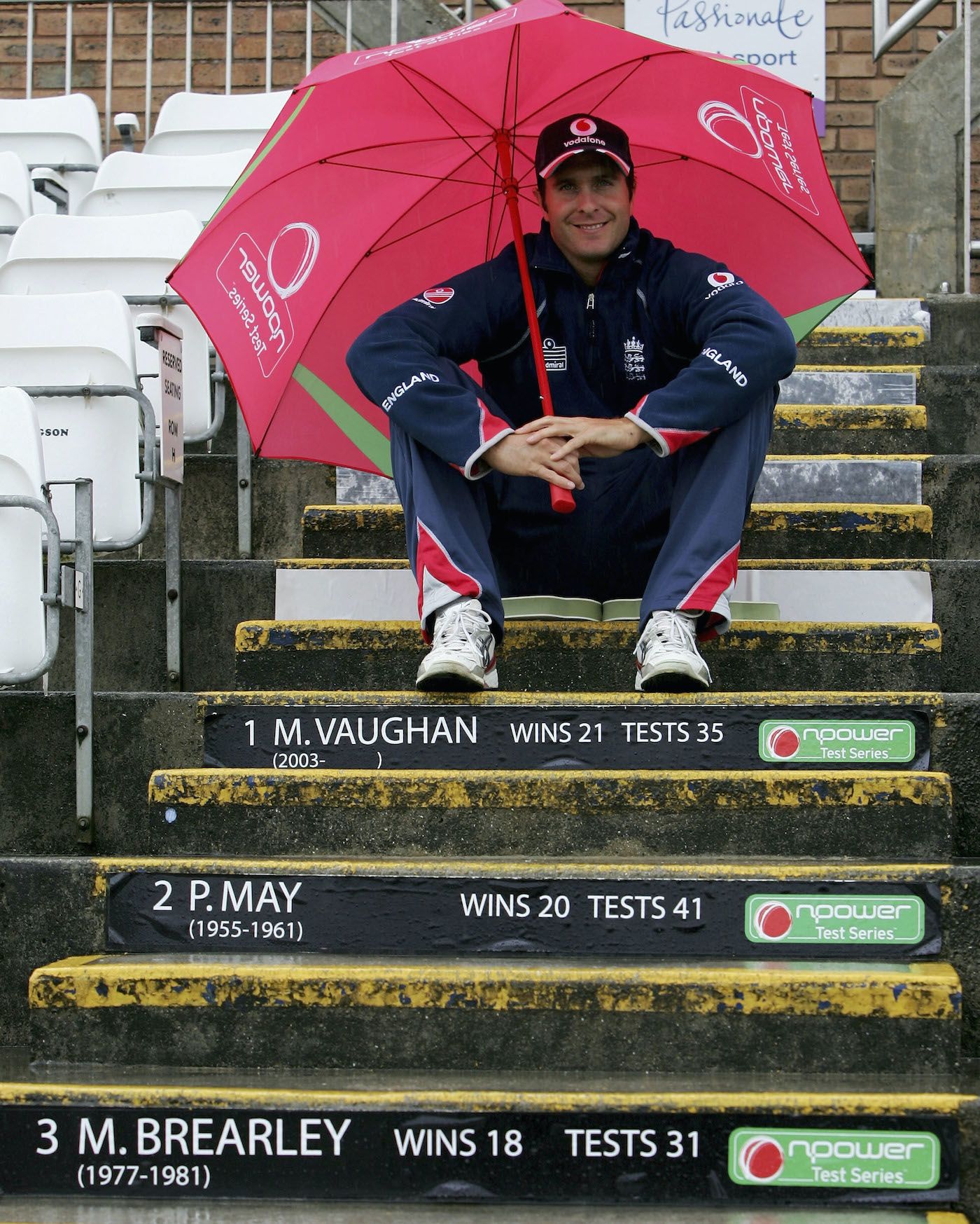 Michael Vaughan sits on the steps above a sign to celebrate his ...