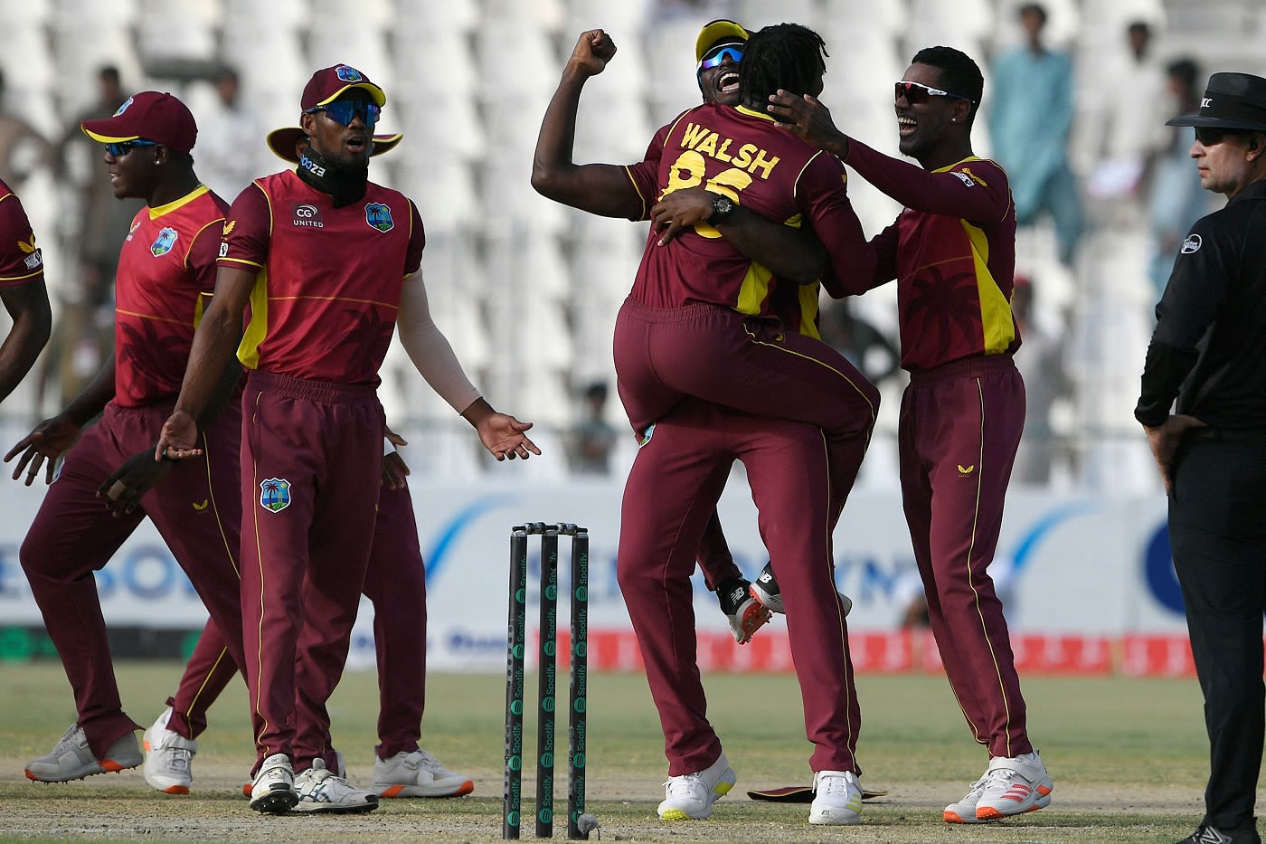 Hayden Walsh Jr is lifted by his team-mates on dismissing Babar Azam ...