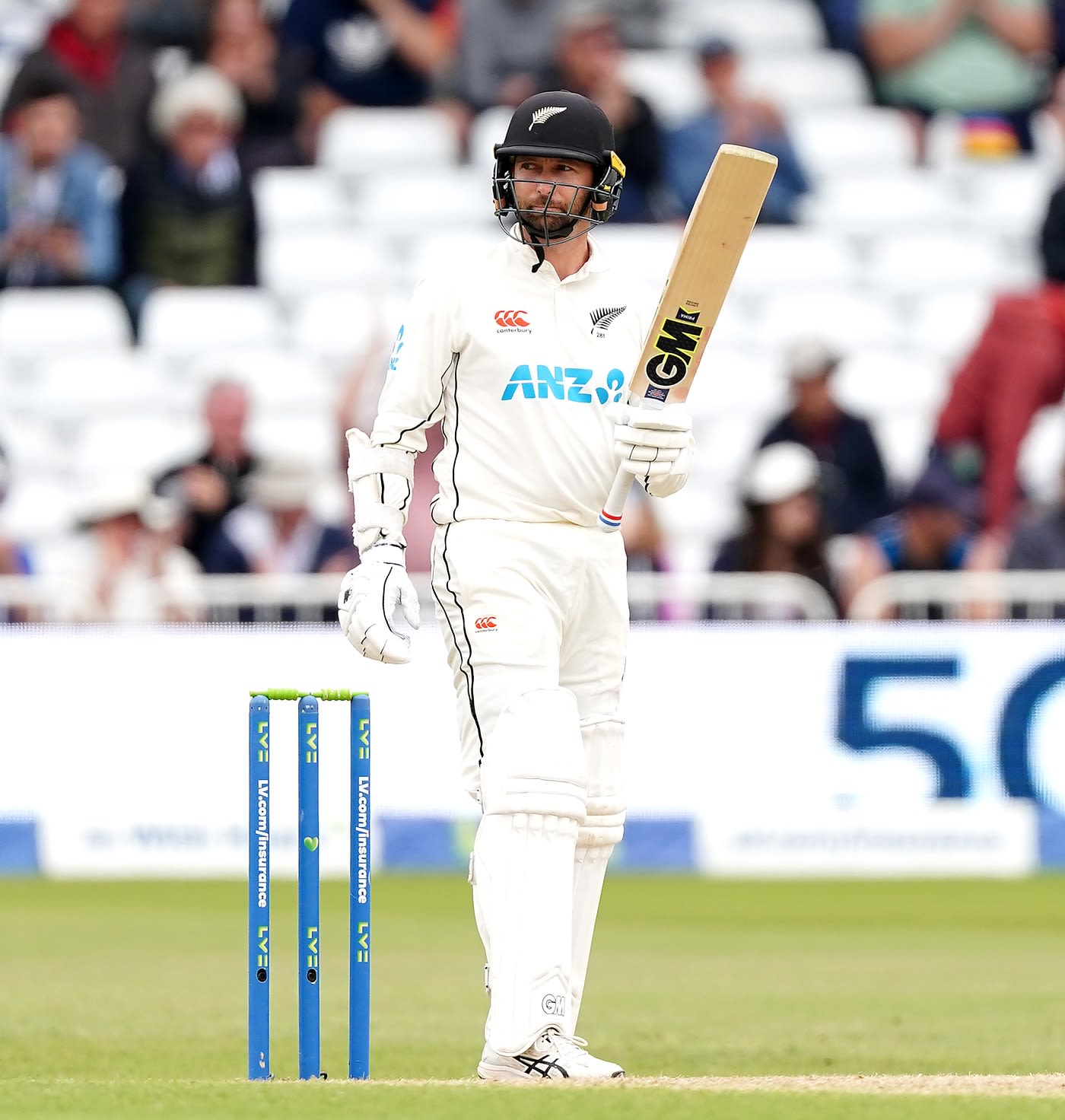Devon Conway raises his bat after scoring a half-century | ESPNcricinfo.com