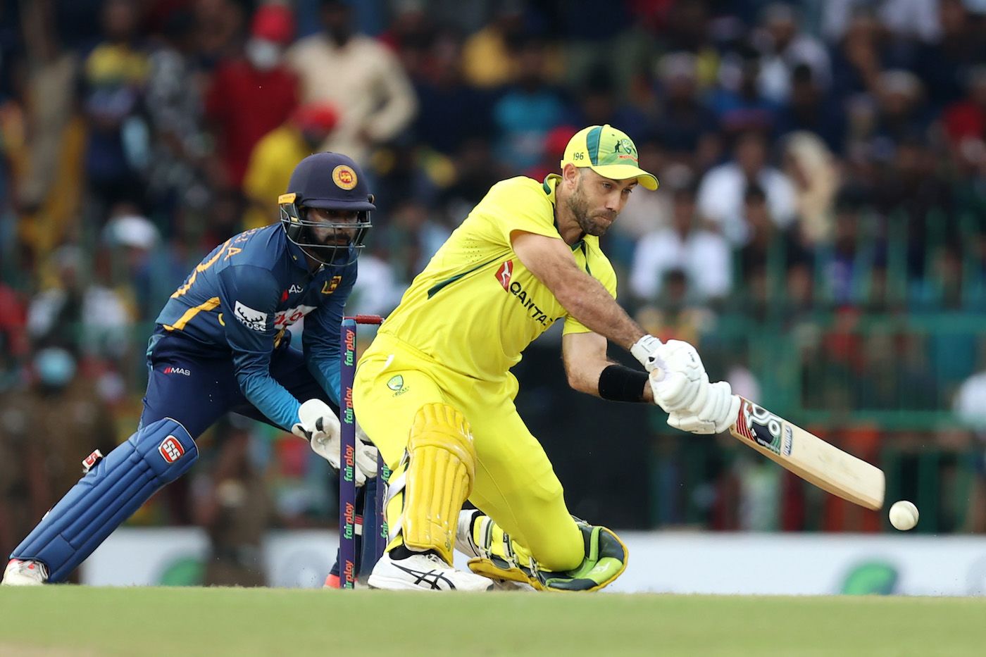 Glenn Maxwell gets down for a reverse sweep | ESPNcricinfo.com