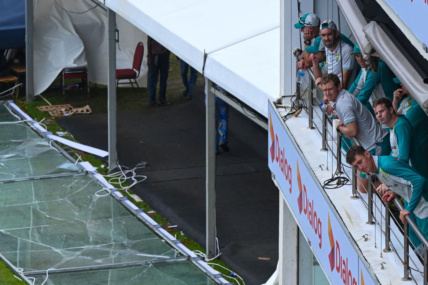 Australian players look after a glass front collapses from a marquee ...