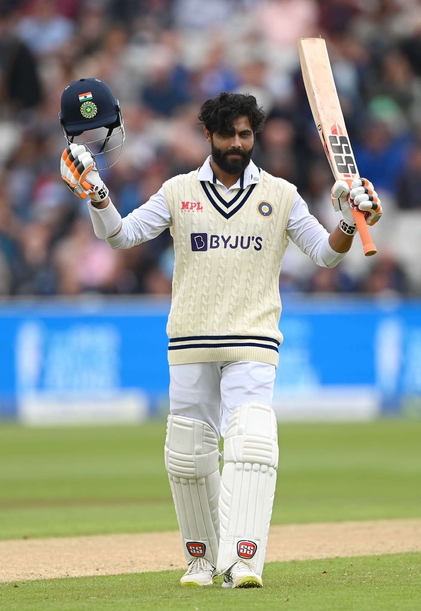 Ravindra Jadeja raises his helmet and bat after scoring his third Test ...