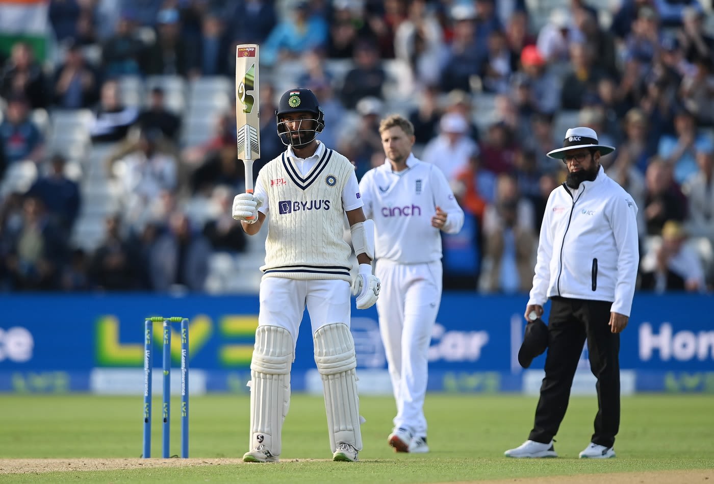 Cheteshwar Pujara raises his bat after reaching fifty | ESPNcricinfo.com
